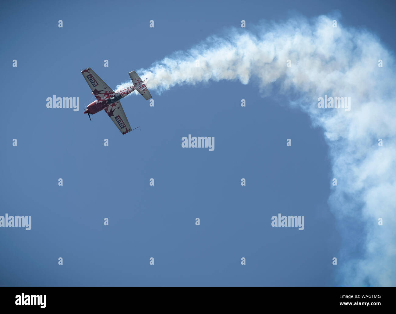 Aerobatic Extra plane in the left hand side doing a loop the loop in a ...