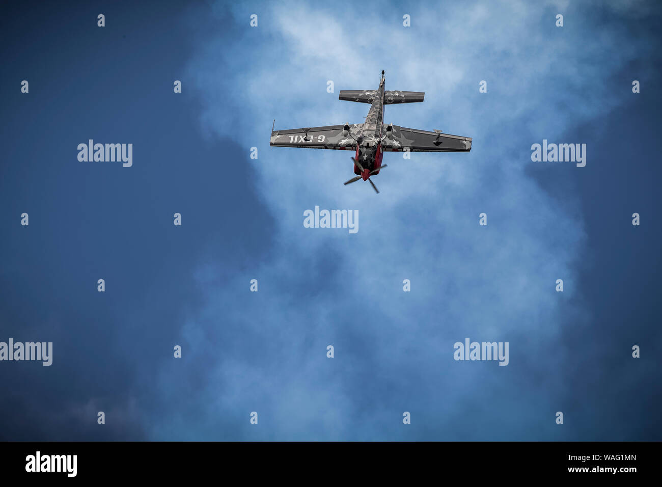 Blades Extra aerobatic plane very high in the sky with a dramatic sky ...