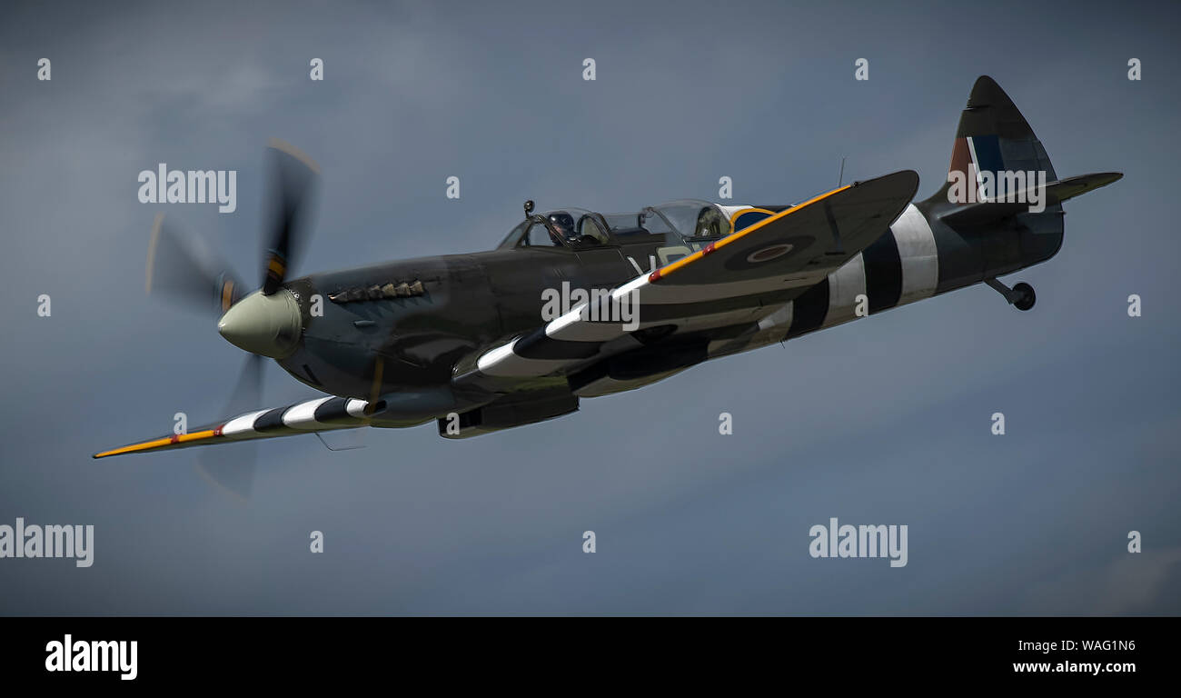 RAF Spitfire Fighter Plane in flightin the sky with blurred propellers ...