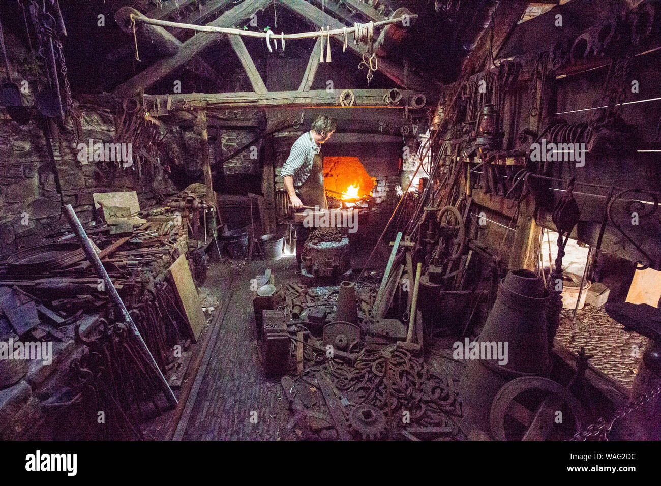 The resident blacksmith at work in the Llawr-y-Glyn Smithy at St Fagans ...
