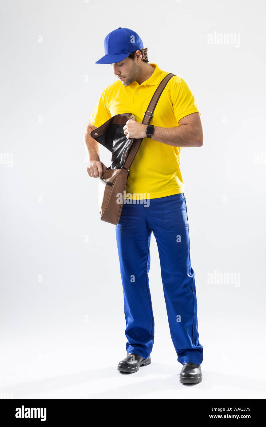 Brazilian mailman on a white background delivering a package. copy ...