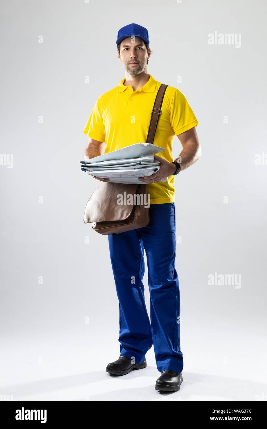Brazilian mailman on a white background delivering a package. copy ...