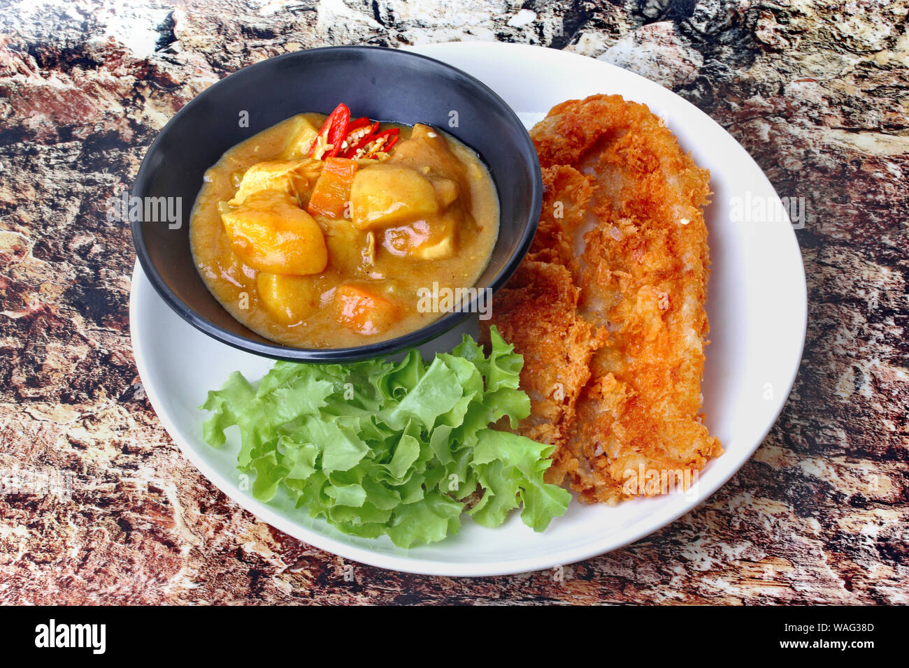 Ready served of crispy fried dolly fish with Japanese yellow curry ...