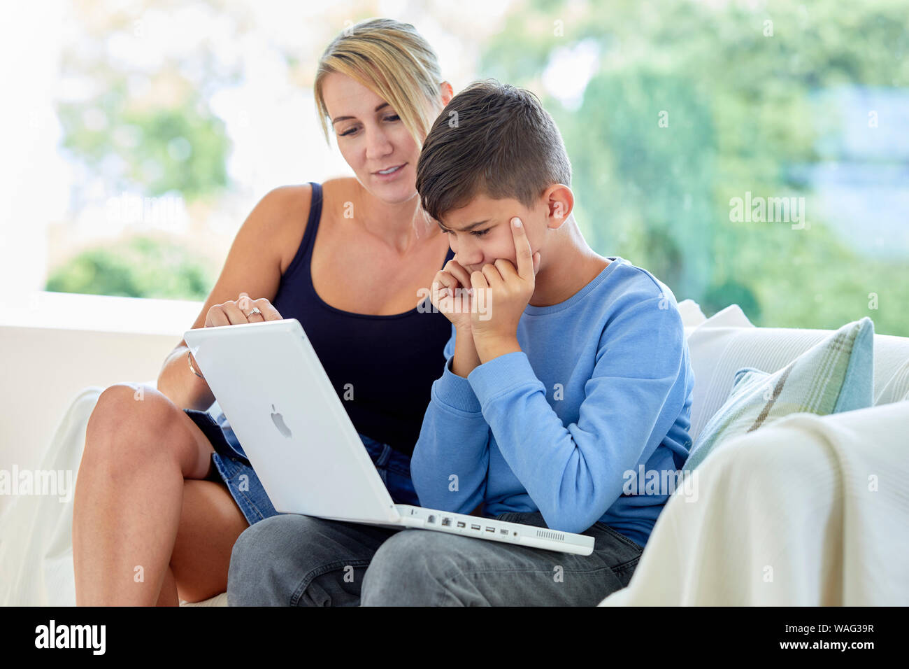 Mother helping her son with homework Stock Photo - Alamy