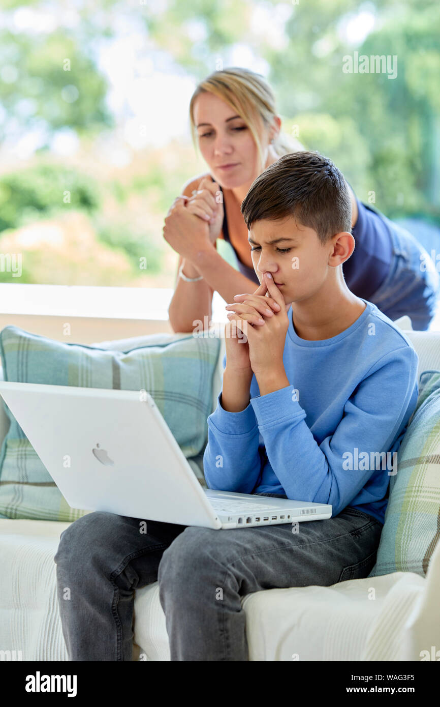 Mother helping her son with homework Stock Photo - Alamy