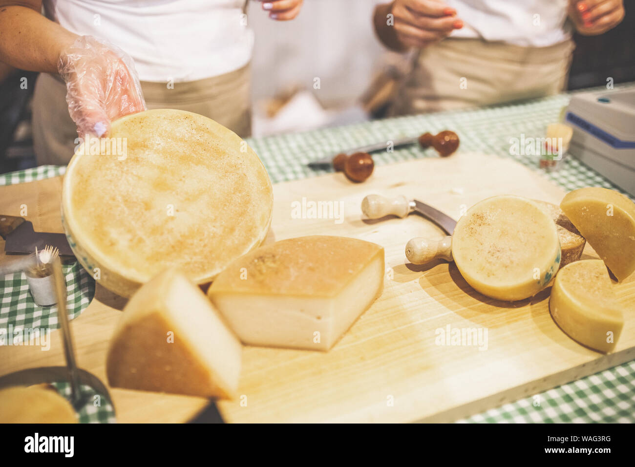 Close up of hand holding cheese at street food stand Stock Photo - Alamy