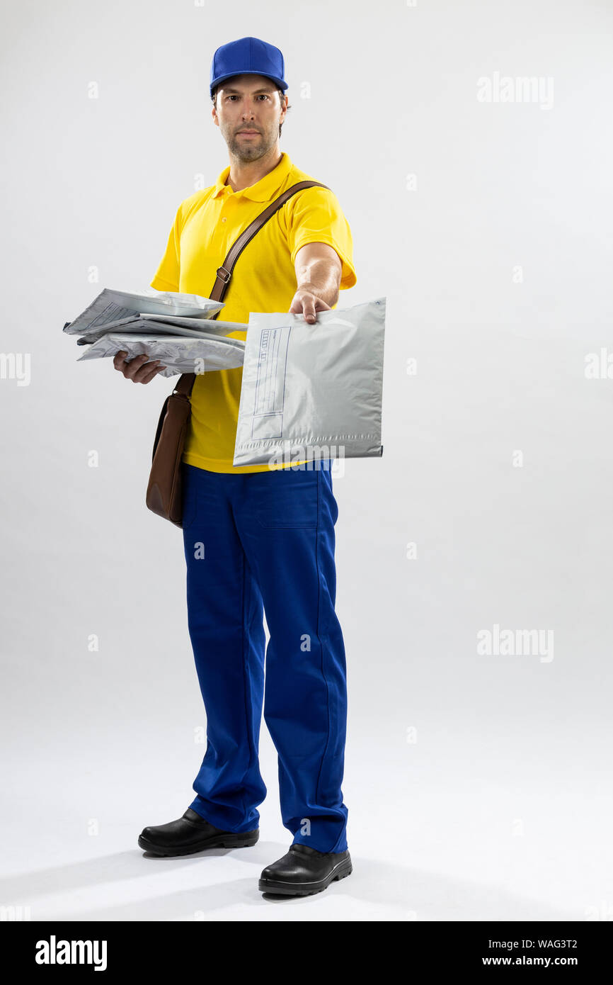Brazilian mailman on a white background delivering a package. copy ...