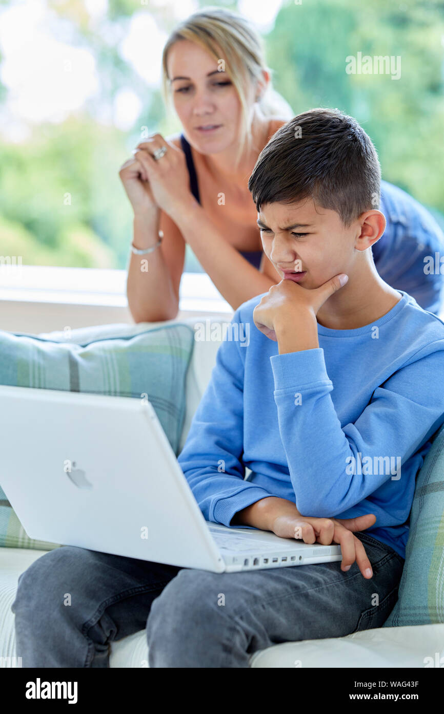 Mother helping her son with homework Stock Photo - Alamy
