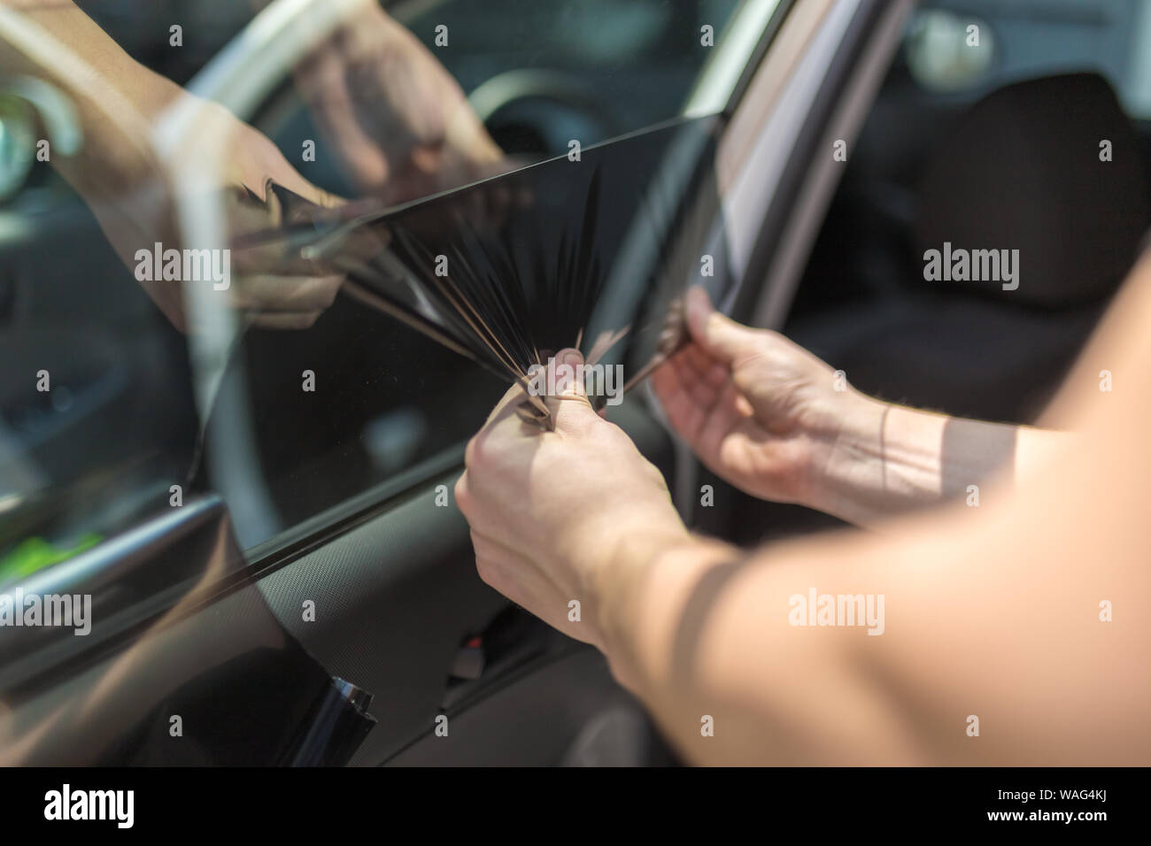 Process of removing sunlight protective car window glass foil Stock ...