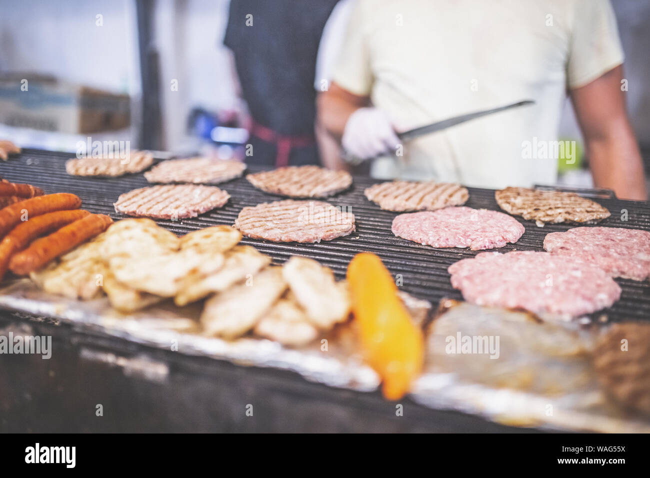 Street food barbecue burger preparation. Fast food concept Stock Photo ...