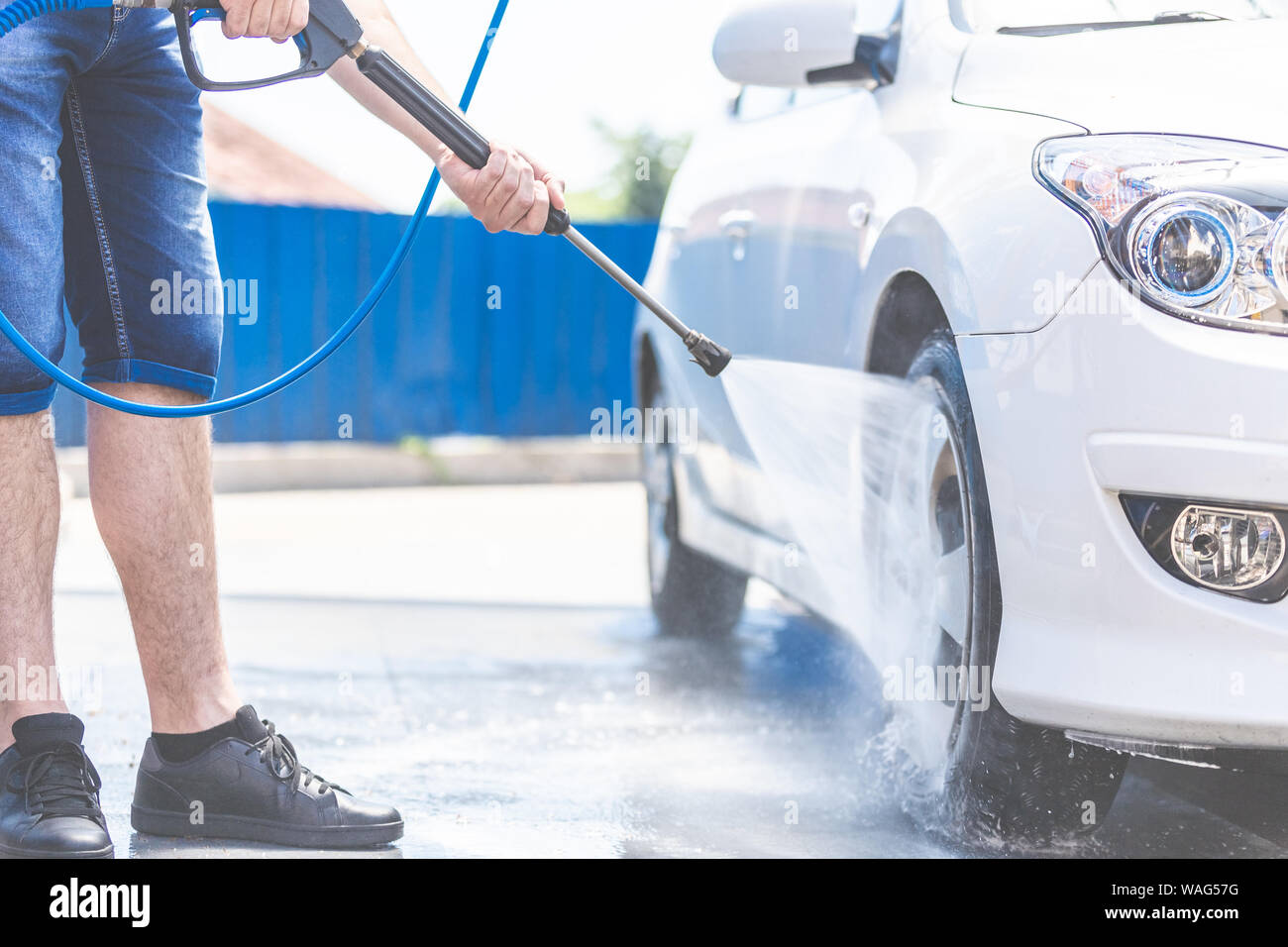 Man washing car wheel with high pressure machine for car wash Stock ...