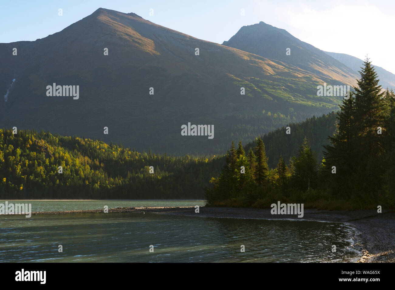 Fog rises from the beautiful blue waters of Vagt Lake near Seward ...