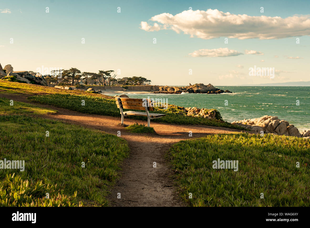 An empty bench in front of the ocean at sunset Stock Photo - Alamy