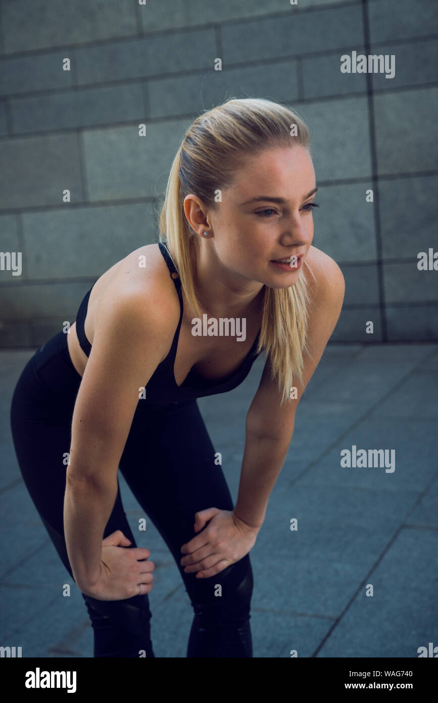 Tired female athlete stretching hi-res stock photography and images - Alamy