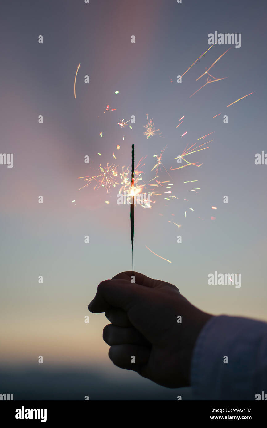Hand holding a burning sparkler Stock Photo - Alamy