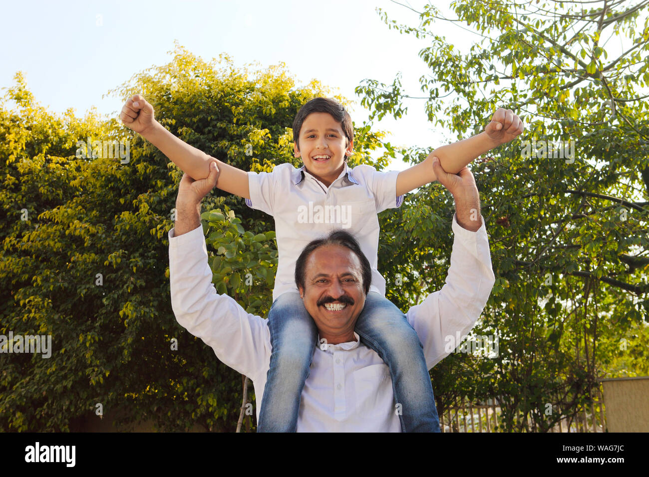 Old man carrying his grandson on his shoulder Stock Photo - Alamy
