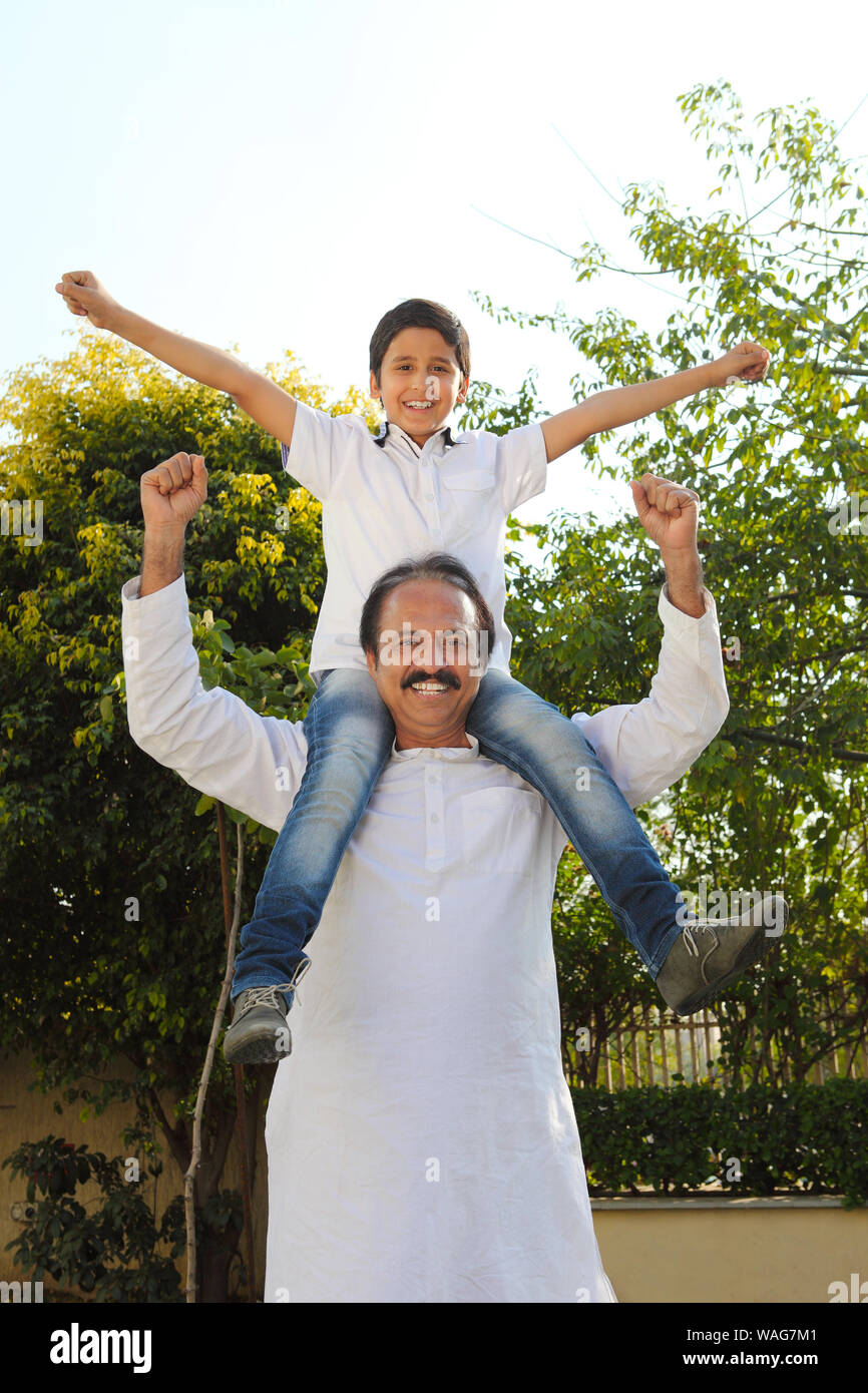 Old man carrying his grandson on his shoulder Stock Photo - Alamy