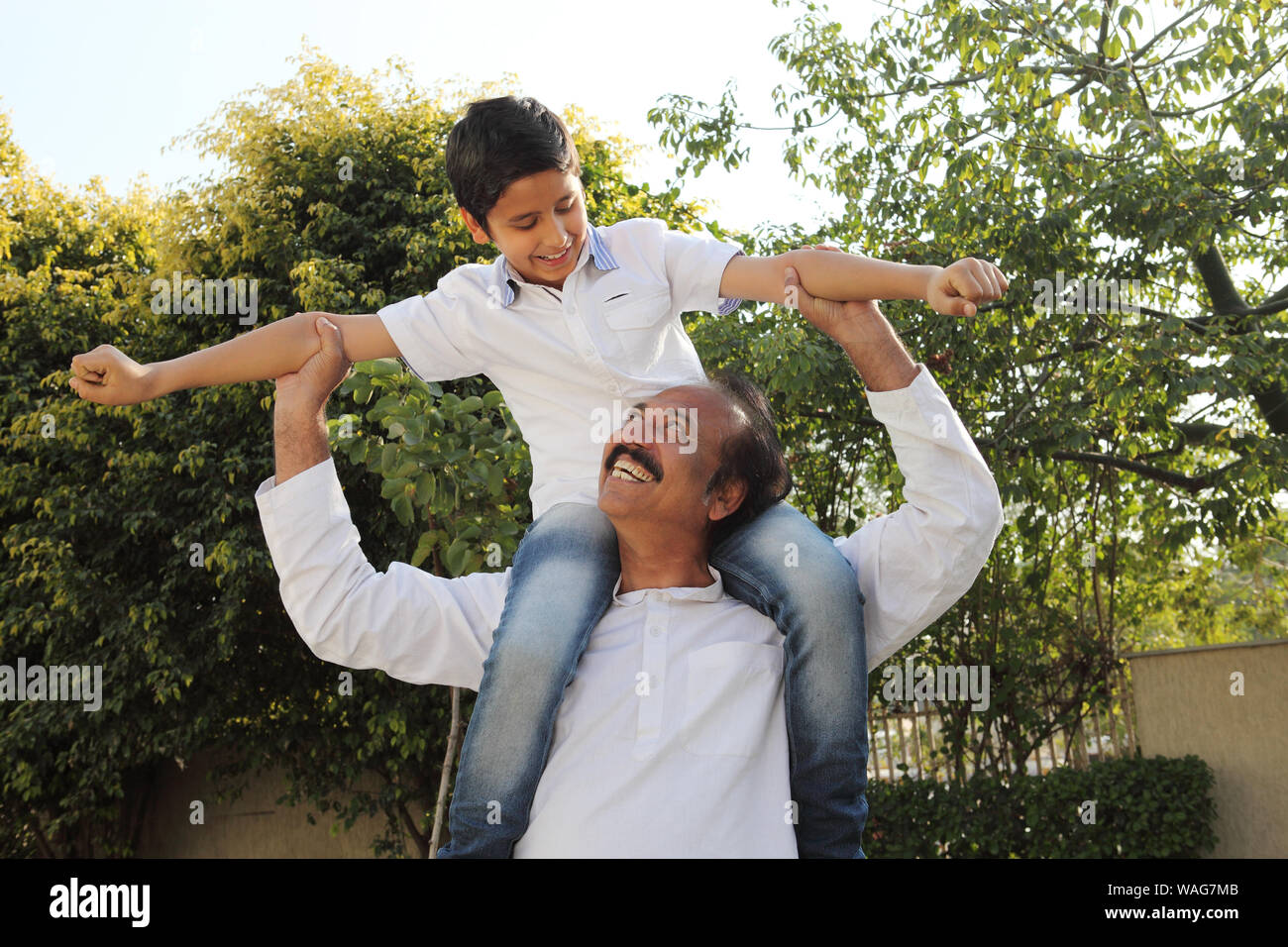 Old man carrying his grandson on his shoulder Stock Photo - Alamy