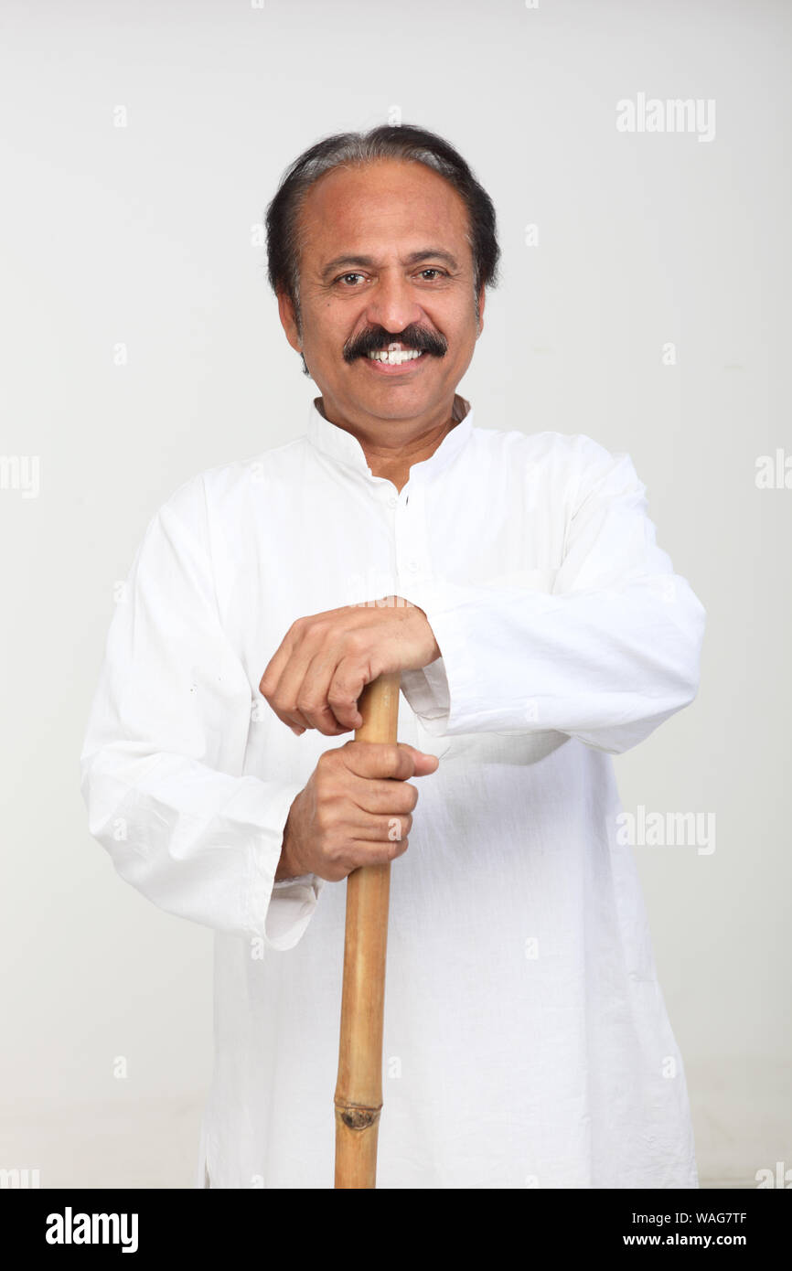 Rural man standing with his cane Stock Photo - Alamy