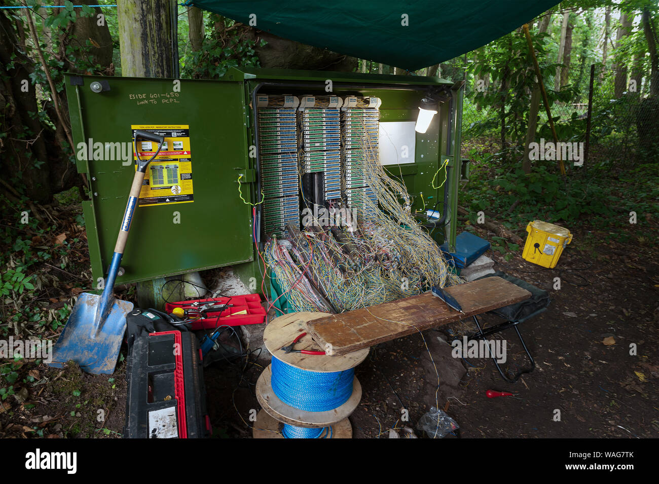 Muddled mass of twisted phone wires in a network box being repaired on ...