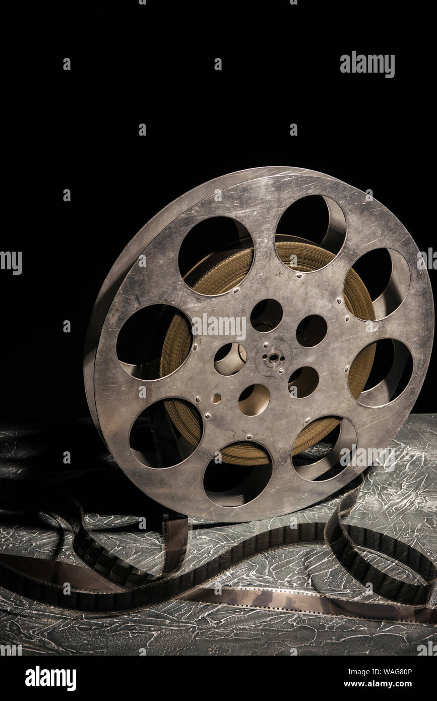 35 mm film reel with dramatic lighting on a dark background - image ...