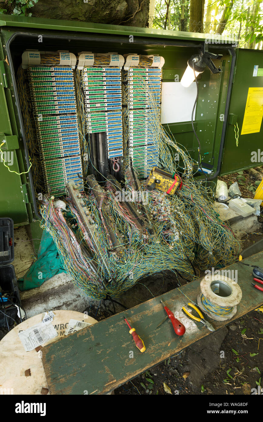 Muddled mass of twisted phone wires in a network box being repaired on ...
