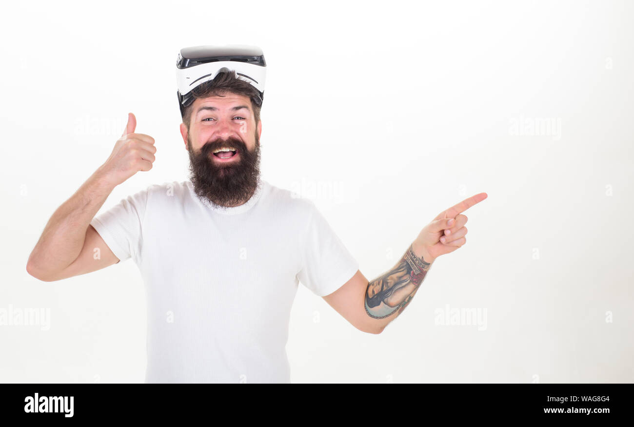 Bearded man wearing virtual reality goggles in studio. Portrait of an ...