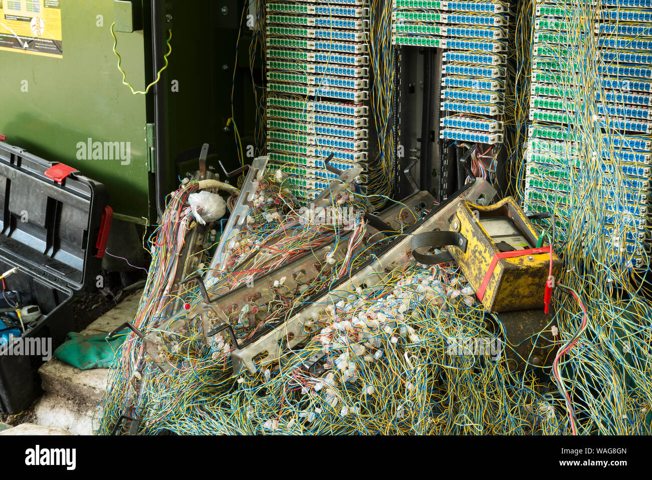 Muddled mass of twisted phone wires in a network box being repaired on ...