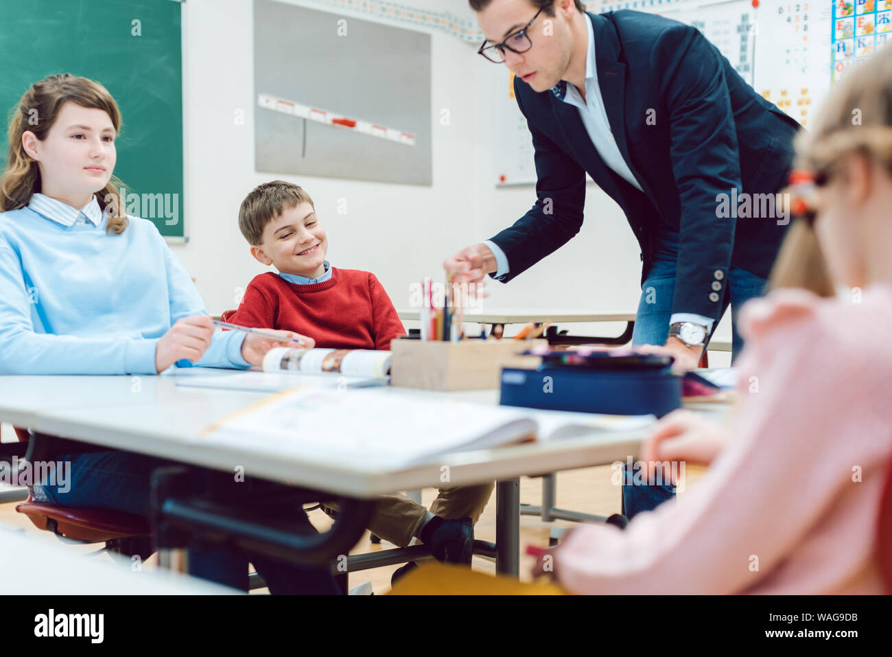 Pupils and teacher cooperating in teamwork exercise Stock Photo - Alamy