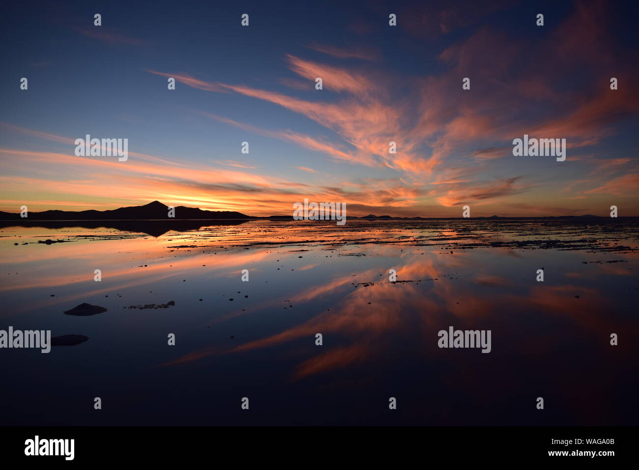 Reflecting sunset in the high plateau of Bolivia Stock Photo - Alamy