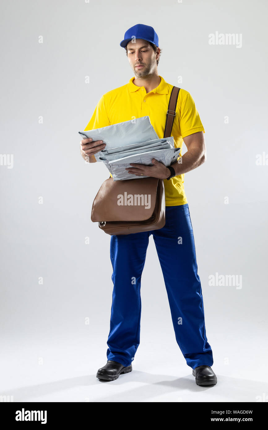 Brazilian mailman on a white background delivering a package. copy ...