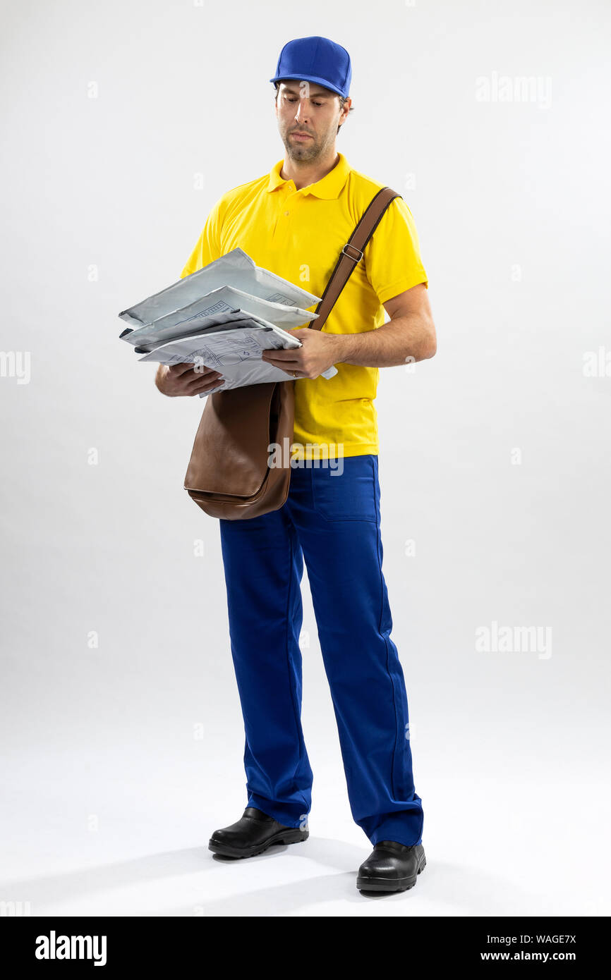 Brazilian mailman on a white background delivering a package. copy ...