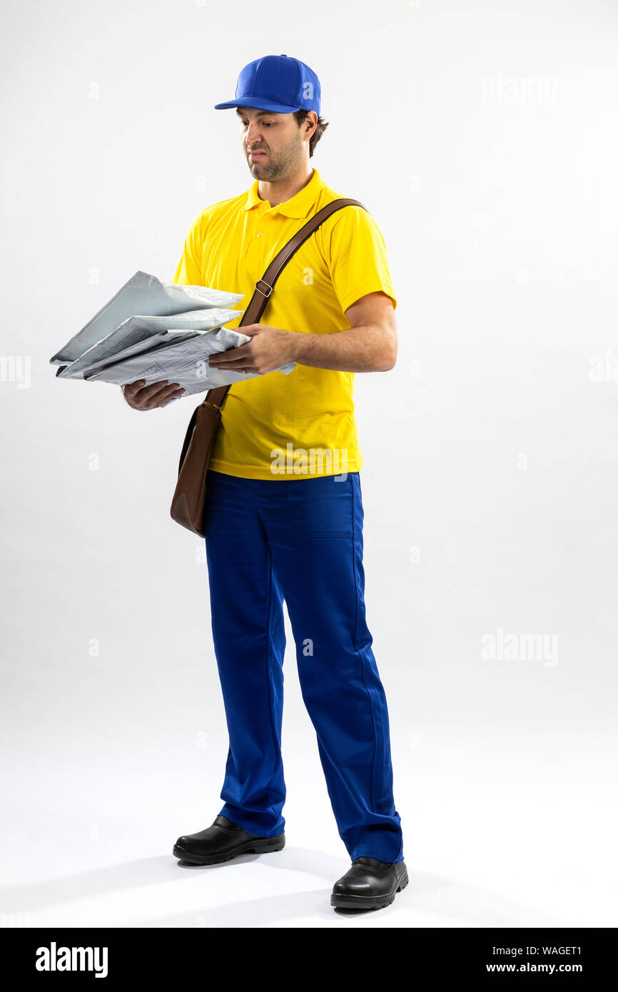 Brazilian mailman on a white background delivering a package. copy ...