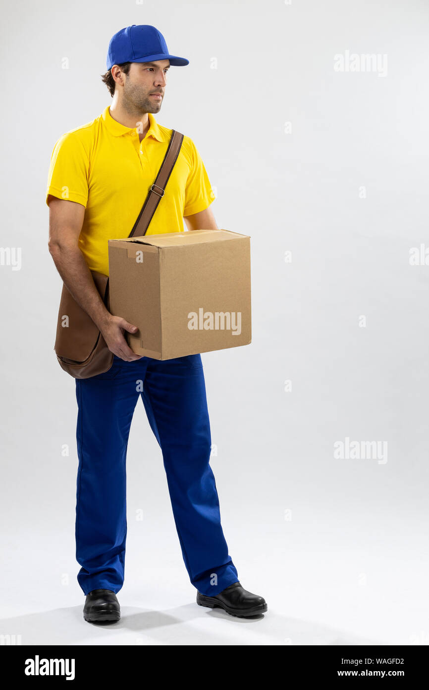 Brazilian mailman on a white background delivering a package. copy ...
