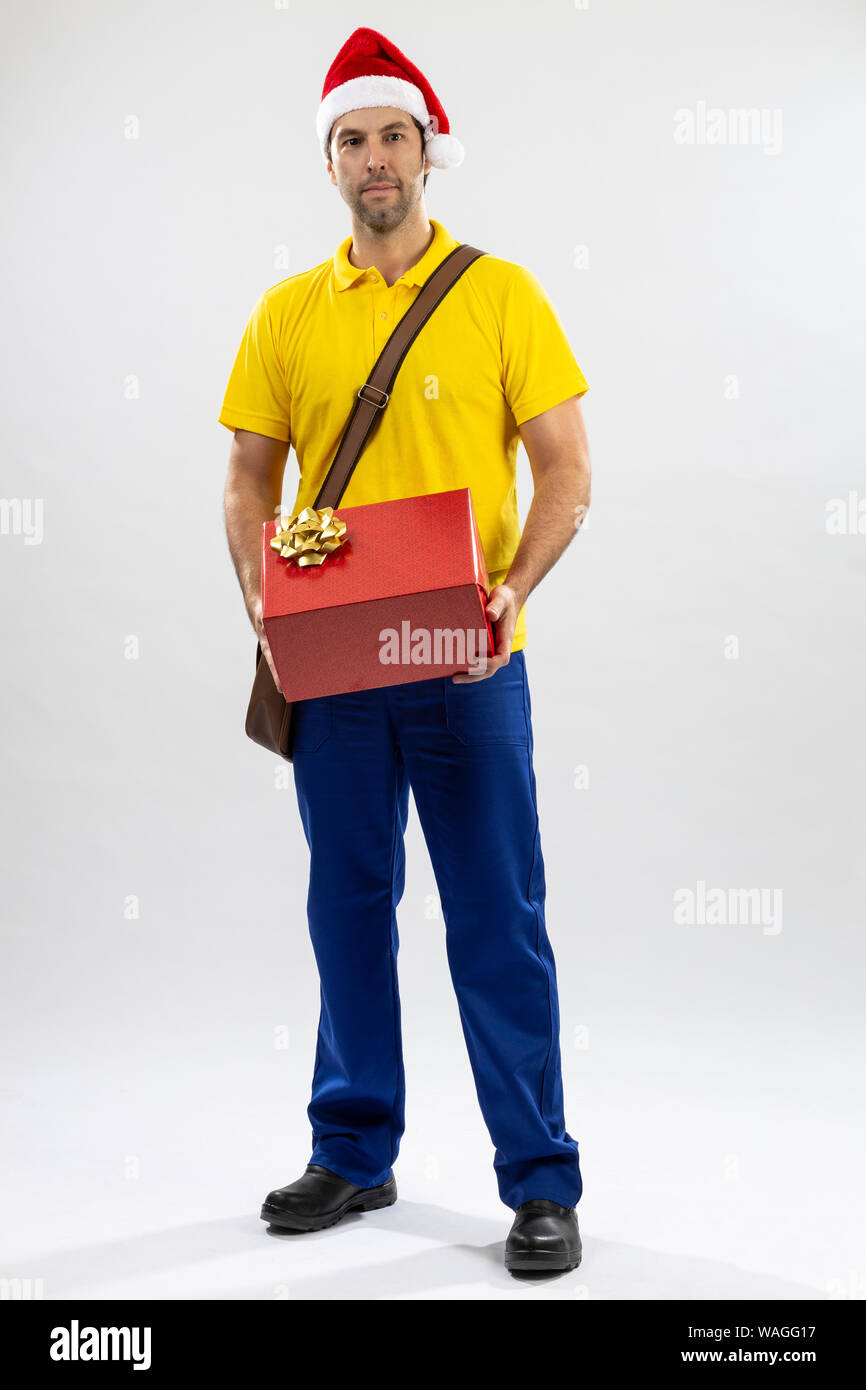 Brazilian mailman dressed as Santa Claus delivering a gift on a white ...