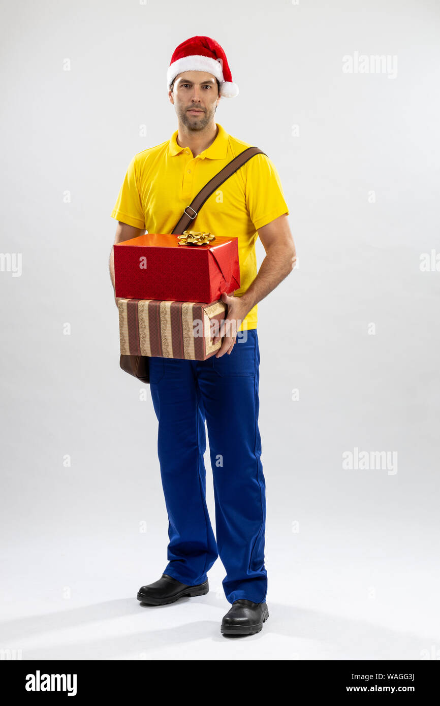 Brazilian mailman dressed as Santa Claus delivering a gift on a white ...