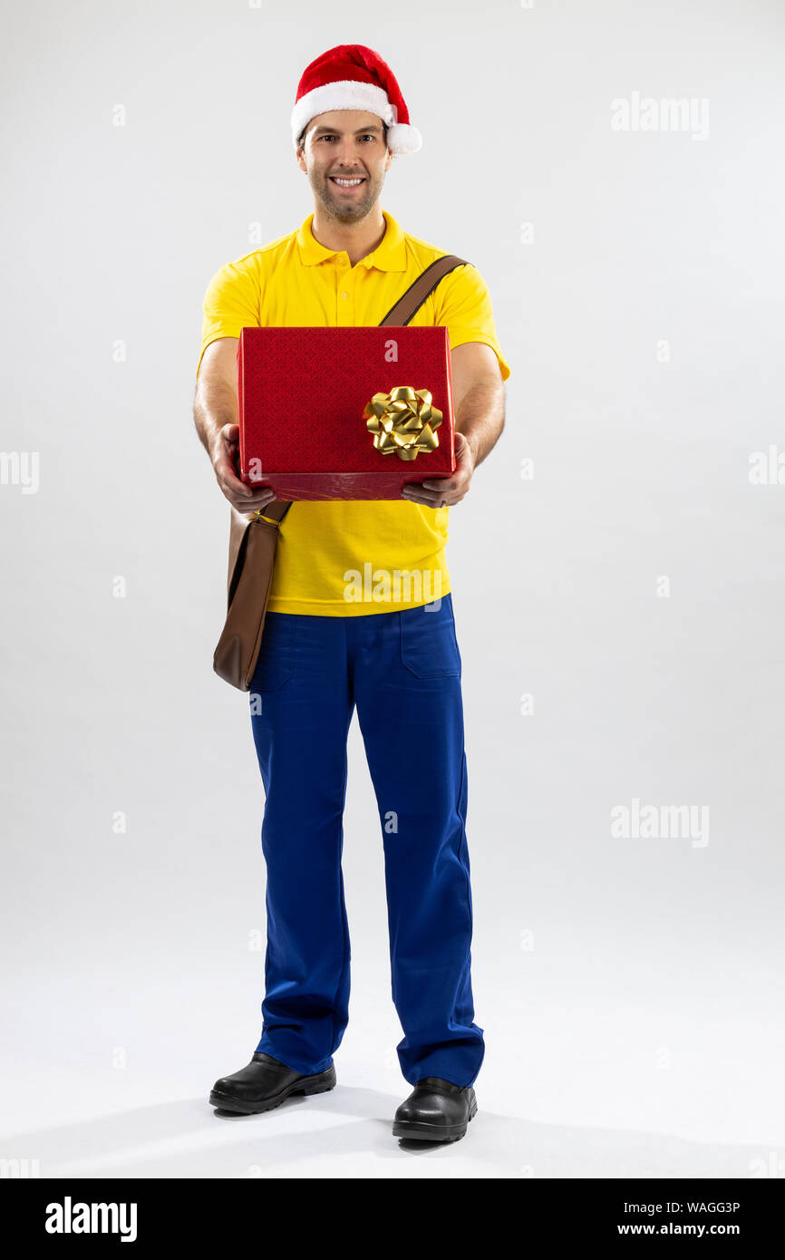 Brazilian mailman dressed as Santa Claus delivering a gift on a white ...