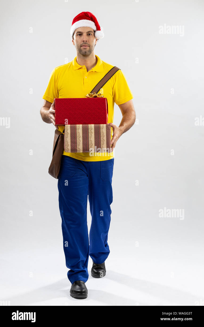 Brazilian mailman dressed as Santa Claus delivering a gift on a white ...