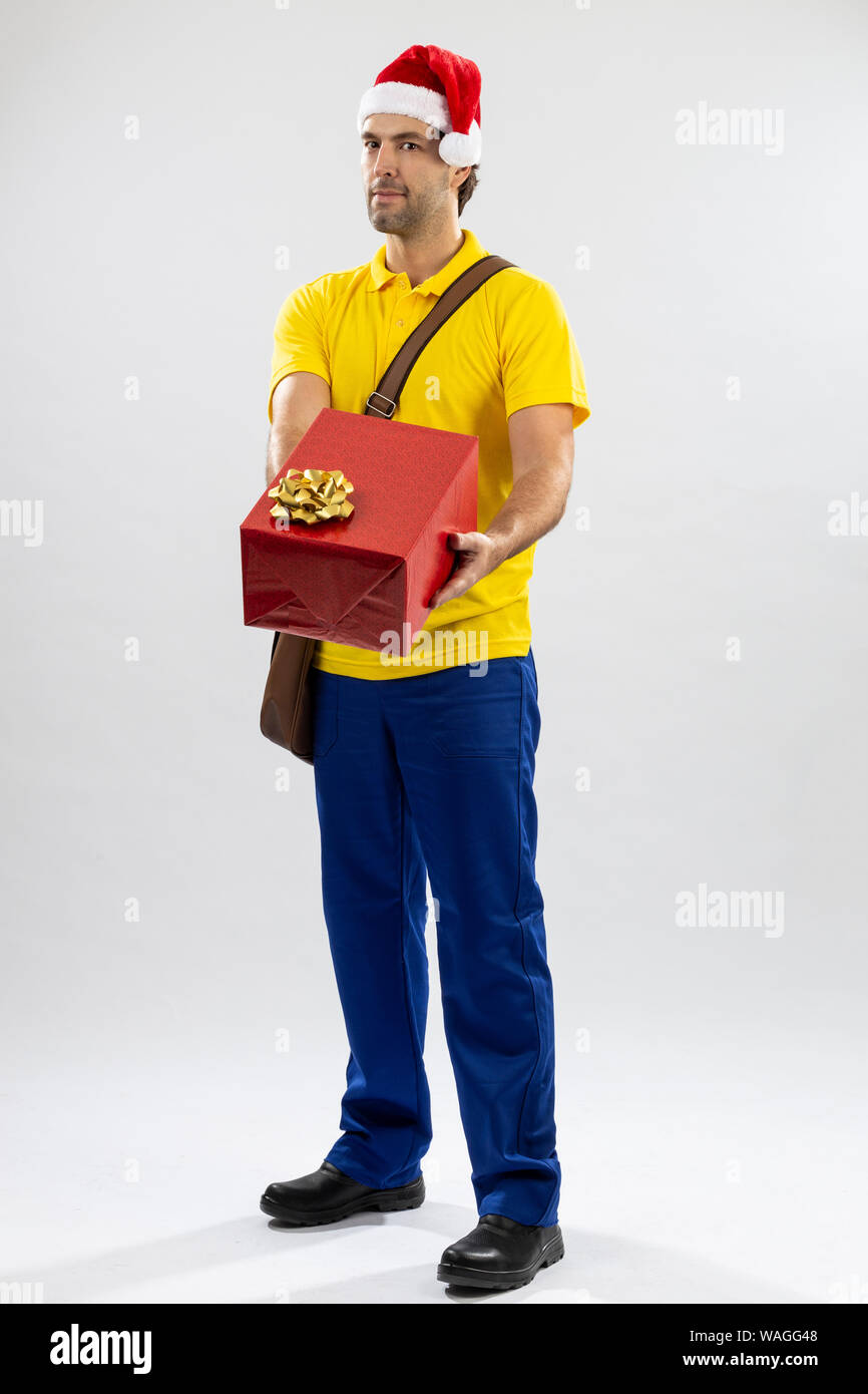 Brazilian mailman dressed as Santa Claus delivering a gift on a white ...