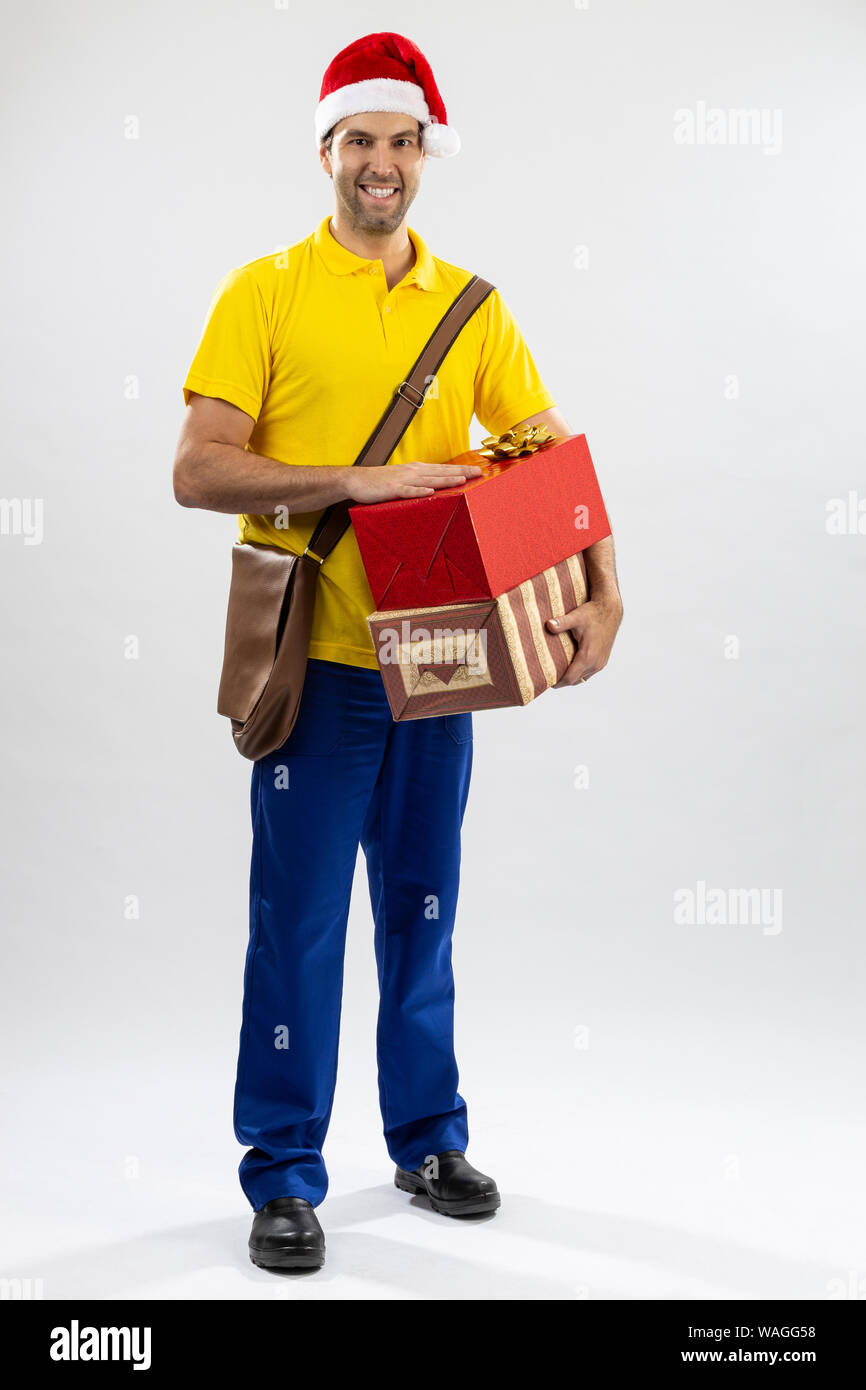 Brazilian mailman dressed as Santa Claus delivering a gift on a white ...