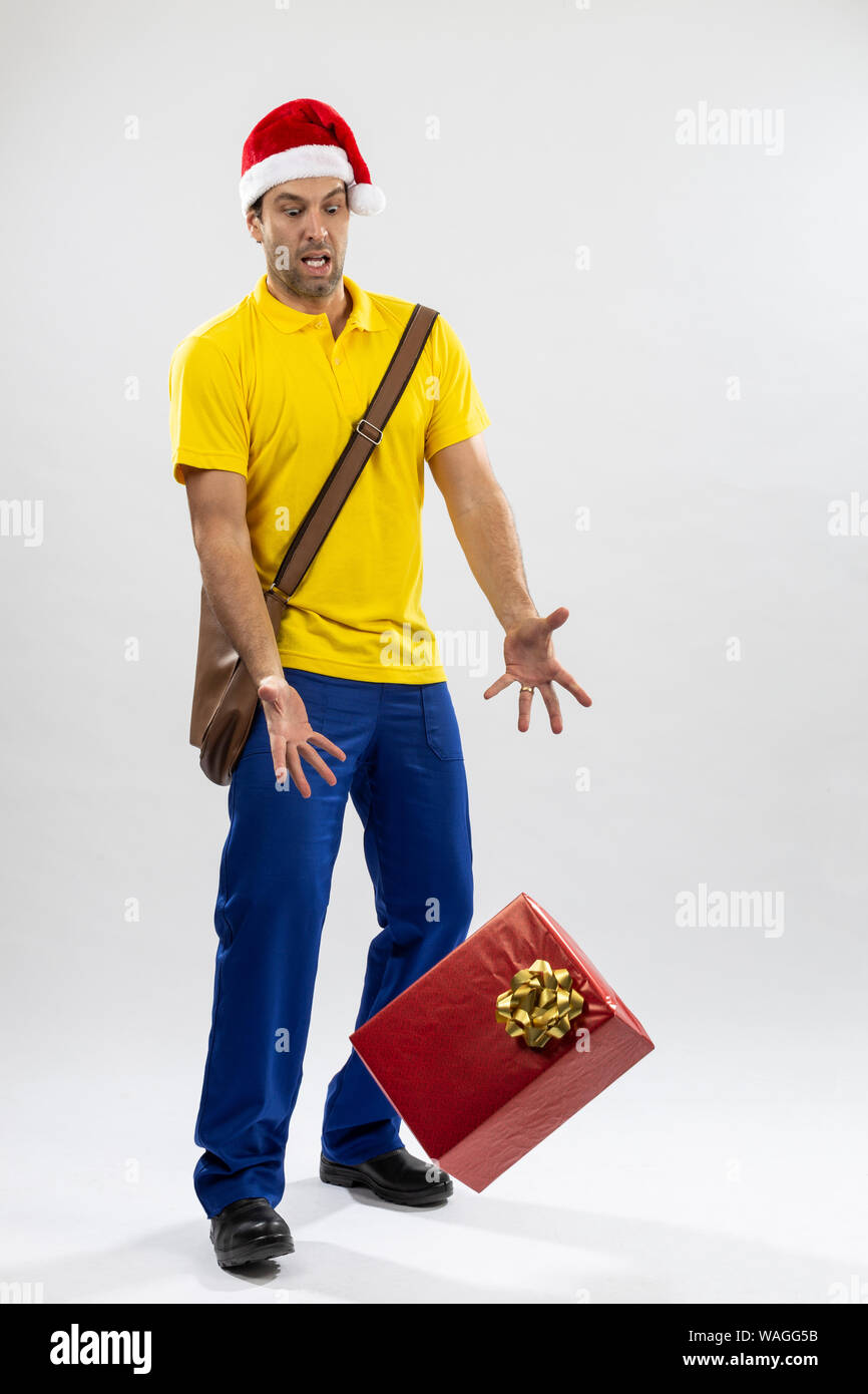 Brazilian mailman dressed as Santa Claus dropping a gift on a white ...