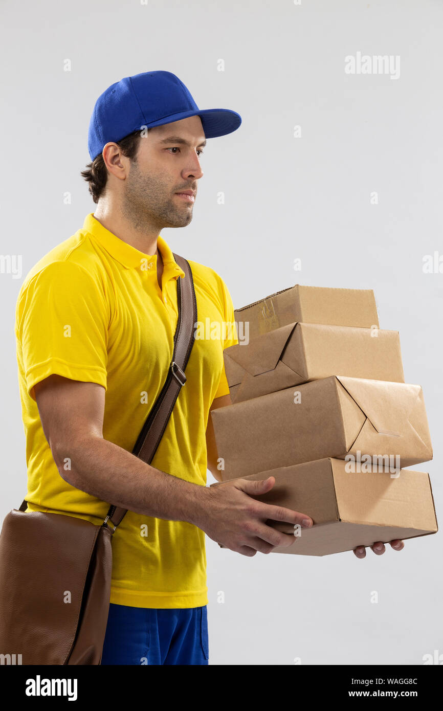 Brazilian mailman on a white background delivering a package. copy ...
