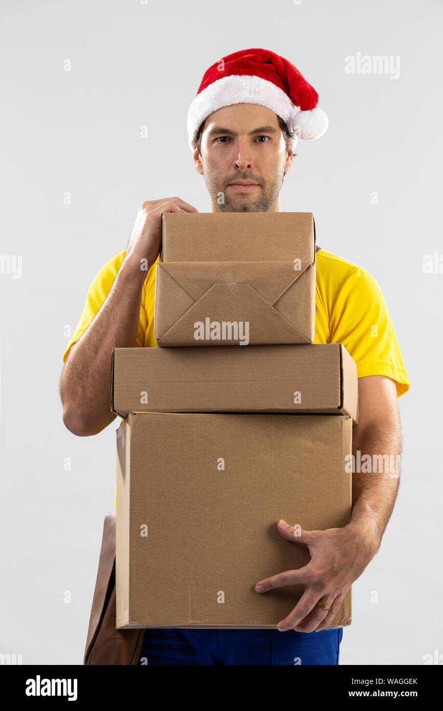Brazilian mailman dressed as Santa Claus delivering a gift on a white ...