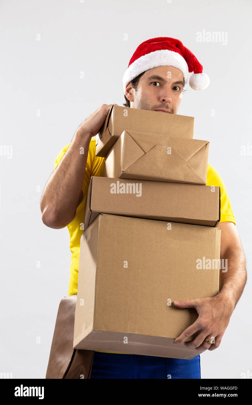 Brazilian mailman dressed as Santa Claus delivering a gift on a white ...