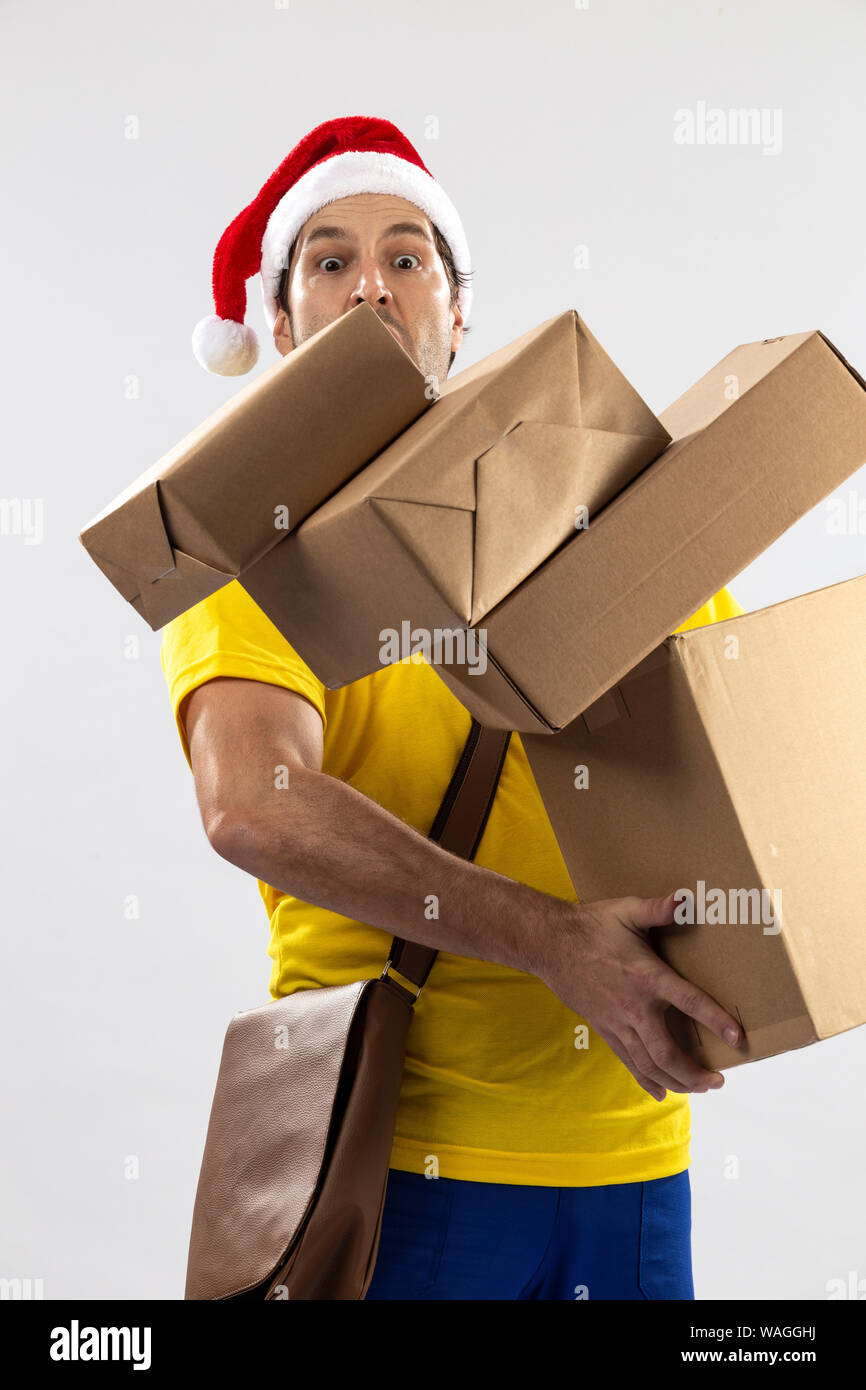 Brazilian mailman dressed as Santa Claus delivering a gift on a white ...