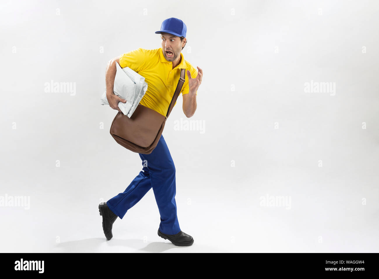 Brazilian mailman running with a package on a white background. copy ...
