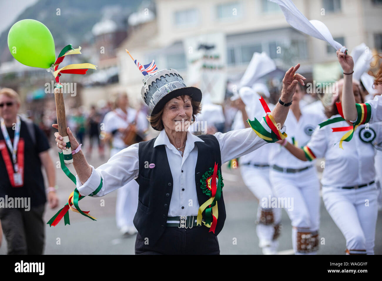 A fool with morris folk dancers at the Sidmouth Folk Week Festival 2019 ...