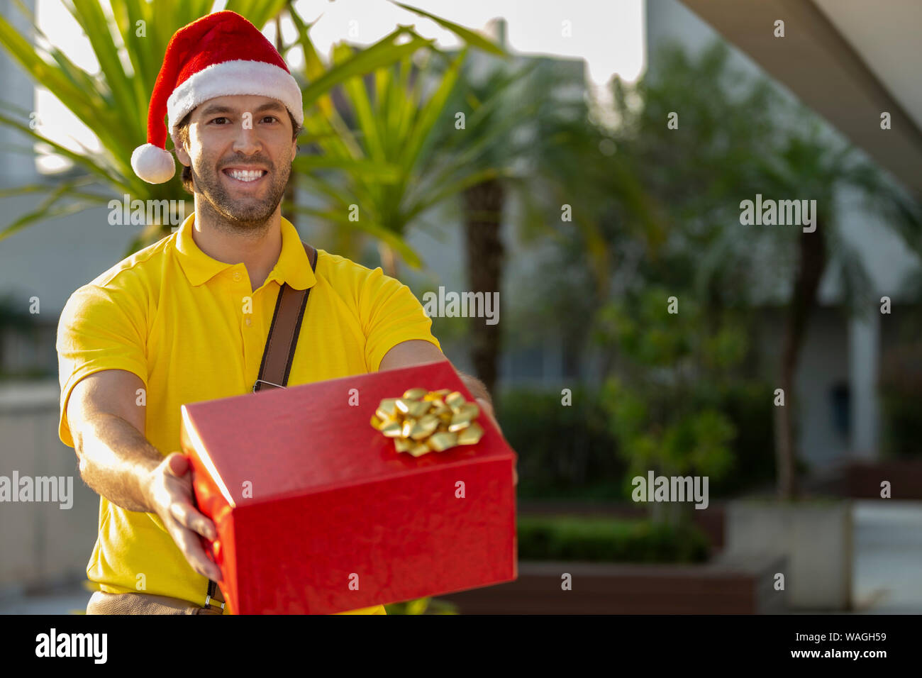 Brazilian mailman dressed as Santa Claus delivering a gift. Online ...