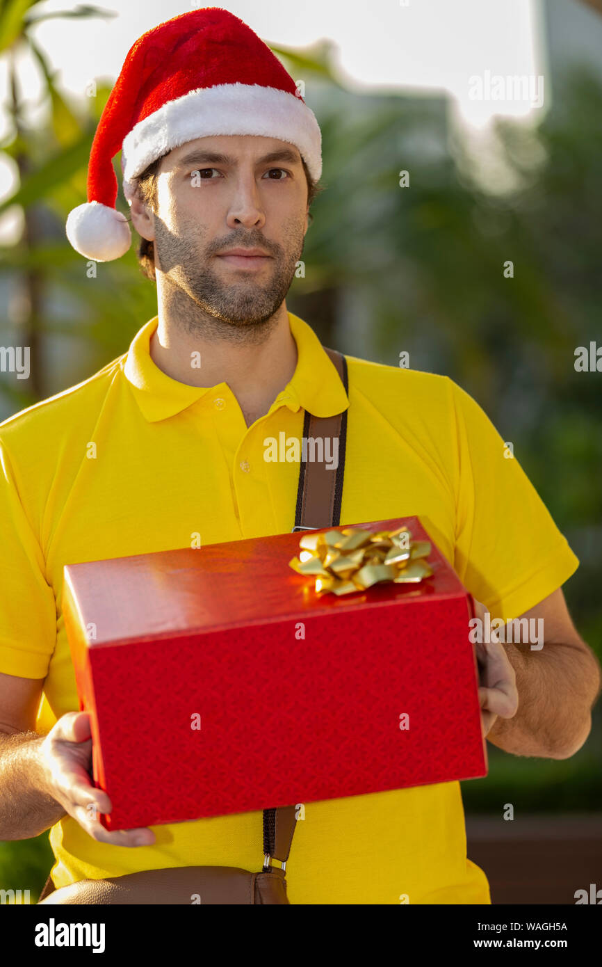 Brazilian mailman dressed as Santa Claus delivering a gift. Online ...