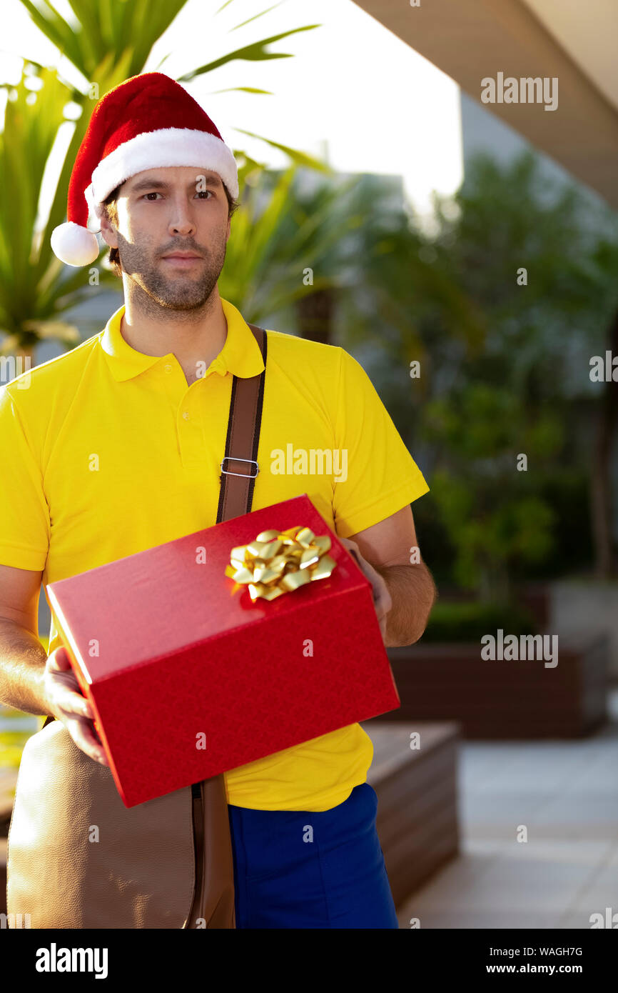 Brazilian mailman dressed as Santa Claus delivering a gift. Online ...